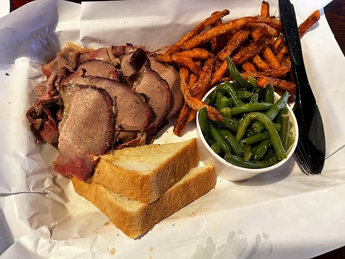 This isn't just brisket—it's a master class in patience. Each slice showcases that coveted pink smoke ring, the barbecue equivalent of Olympic gold.