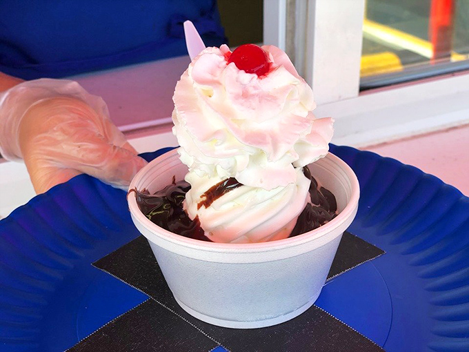 This hot fudge sundae isn't just dessert, it's architecture—layers of vanilla, chocolate, and whipped cream creating the Taj Mahal of treats.