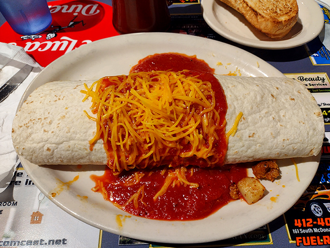 The Famous Breakfast Burrito arrives like a gift-wrapped package of morning bliss, smothered in Spanish sauce and melted cheese.