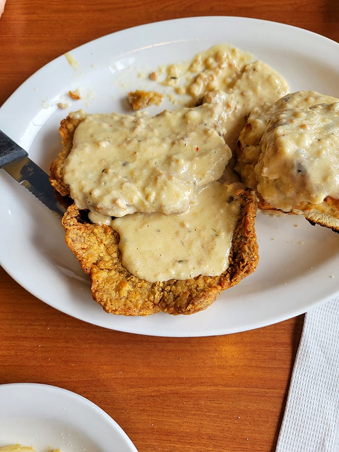 This chicken fried steak isn't just dinner, it's an engineering marvel – crispy exterior, tender interior, and gravy that should have its own fan club.