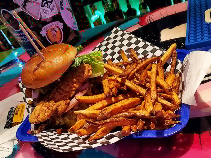 A sandwich that requires both hands and several napkins is always a good sign. This one comes with golden onion rings that crunch like autumn leaves.
