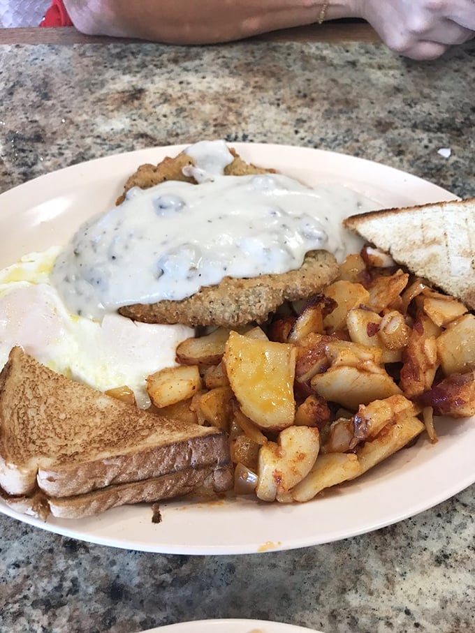This isn't just country fried steak—it's edible therapy. Crispy exterior, tender meat, and that gravy could make cardboard taste like a delicacy.