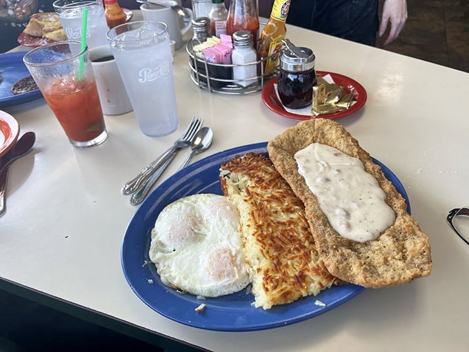 This isn't just country fried steak—it's edible therapy on a blue plate, with hash browns that achieved the perfect crisp-to-tender ratio scientists still can't explain.