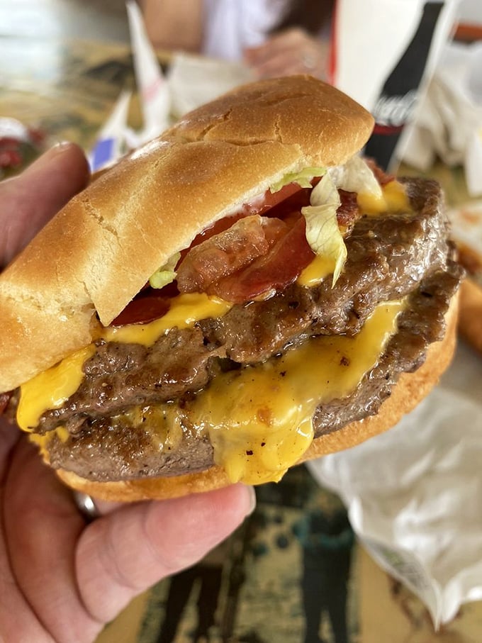 This isn't just a double cheeseburger—it's a towering monument to the art of American roadside cuisine, glistening with melty defiance.