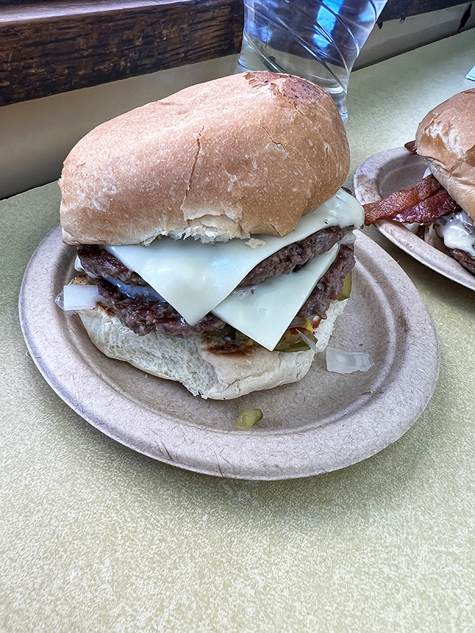 This isn't just a double cheeseburger—it's a masterclass in proper meat-to-cheese ratio, served on a paper plate that knows its place.