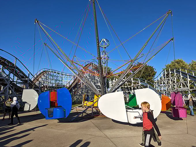 The Flying Scooters – where riders become pilots, controlling their own flight path with those metal fins. Retro thrills that still deliver genuine squeals of delight.