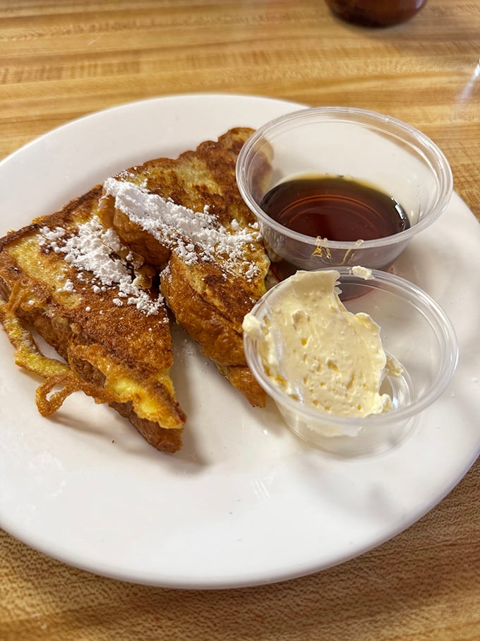 French toast that makes you question why you ever attempted to make it at home. That dusting of powdered sugar? Chef's kiss.