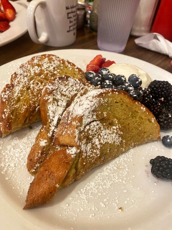 French toast that's achieved celebrity status, complete with berry entourage and powdered sugar confetti. This isn't breakfast—it's an event.