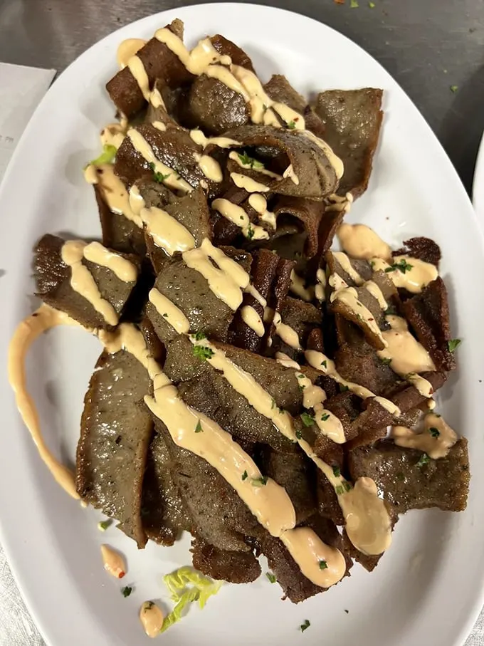 Sliced gyro meat glistening with promise and drizzled with sauce that would make the gods on Mount Olympus put down their ambrosia in jealousy.