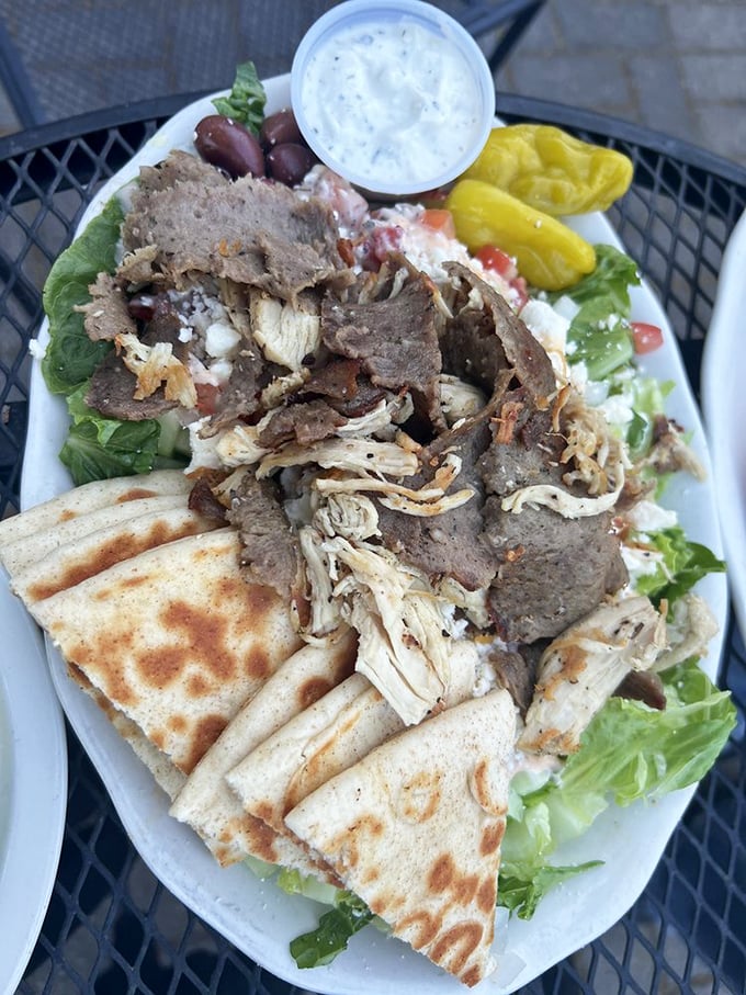 This Greek salad is what happens when vegetables get dressed up for a special occasion—complete with a tzatziki crown and pita sidekicks.