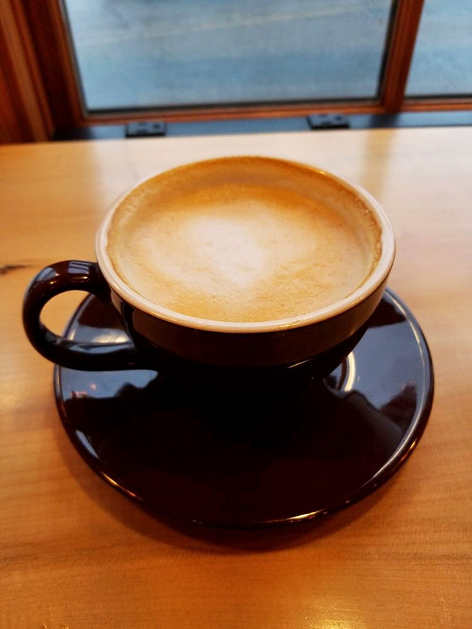 A latte so perfectly crafted it deserves its own Instagram account. The rich amber crema against that dark ceramic cup is coffee's version of a sunset over the mountains.