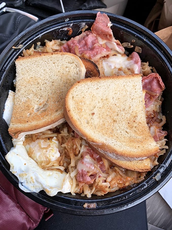 A skillet of pure comfort—crispy hash browns, savory pastrami, and eggs create the holy trinity of diner perfection. Toast for dipping is non-negotiable.