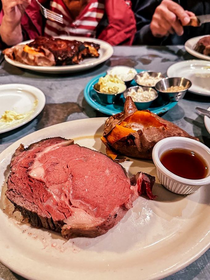 This isn't just prime rib—it's a carnivore's dream canvas, painted in perfect shades of pink with a sweet potato sidekick stealing some well-deserved spotlight.