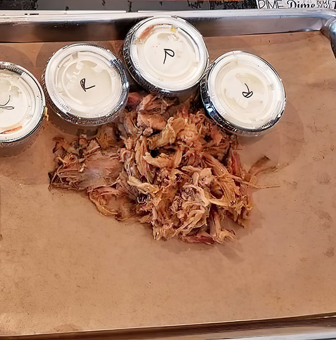 Pulled pork so tender it practically shredded itself. The containers of sauce are just formalities—this meat stands gloriously on its own.