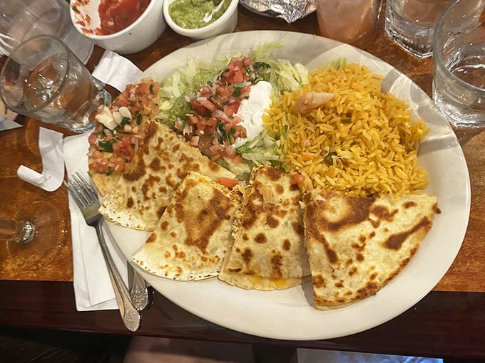 Quesadillas done right—properly browned tortillas, cheese that actually stretches, and rice that respects itself enough not to clump together.