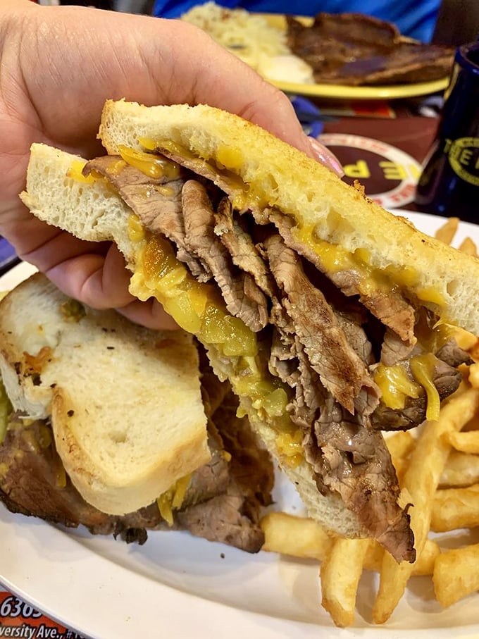 This isn't just a sandwich; it's a masterclass in beef architecture. The melted cheese acts as delicious mortar between layers of thinly sliced heaven.