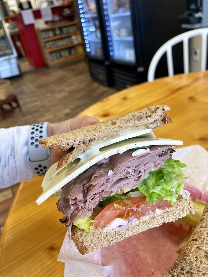 Not just a sandwich, but an architectural marvel of thinly sliced roast beef, Swiss cheese, fresh veggies, and what appears to be the perfect ratio of meat to bread.