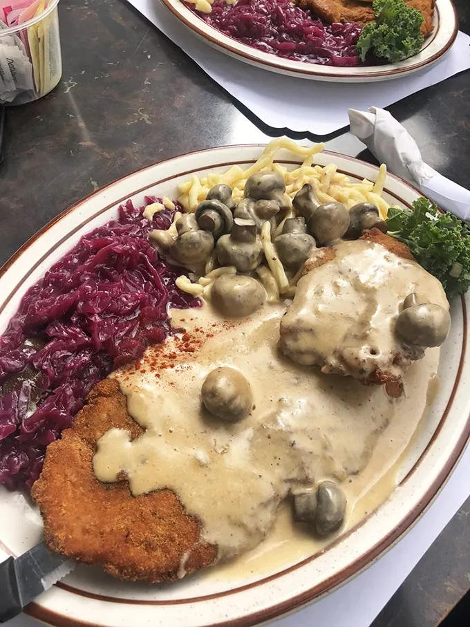 Jäger Schnitzel that would make your German grandmother weep with joy—crispy, tender, and swimming in mushroom sauce that deserves its own fan club.