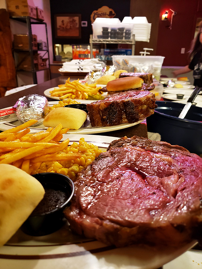 The lineup at Big Ed's pass-through window looks like a parade of Kansas' greatest hits—each plate a testament to the "bigger is better" philosophy.