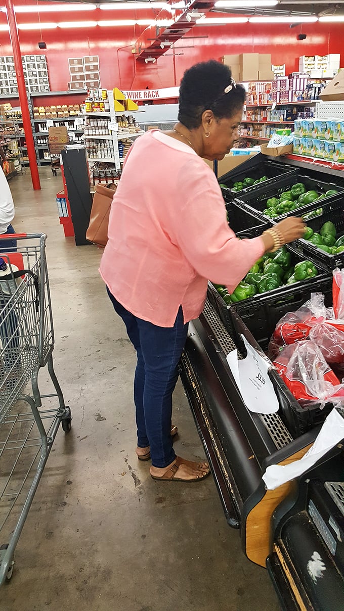 Shoppers carefully selecting the freshest produce—proving that bargain hunting and quality ingredients aren't mutually exclusive culinary concepts.