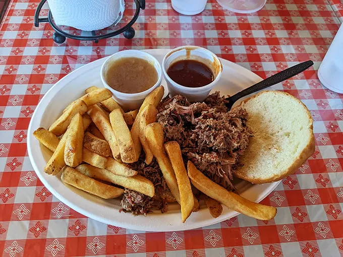 The pulled pork sandwich—where sauce cups aren't suggestions but necessities. Though honestly, this meat is so good it could go commando.