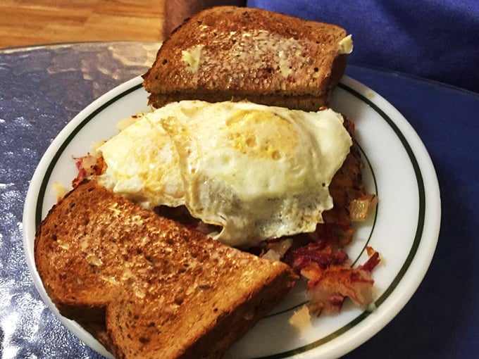 Corned beef hash crowned with perfectly cooked eggs—the breakfast equivalent of finding a twenty in your winter coat pocket. Unexpected joy on a plate.