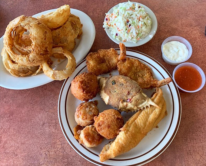 The seafood platter arrives like a greatest hits album—onion rings, hush puppies, and fried treasures from the deep.