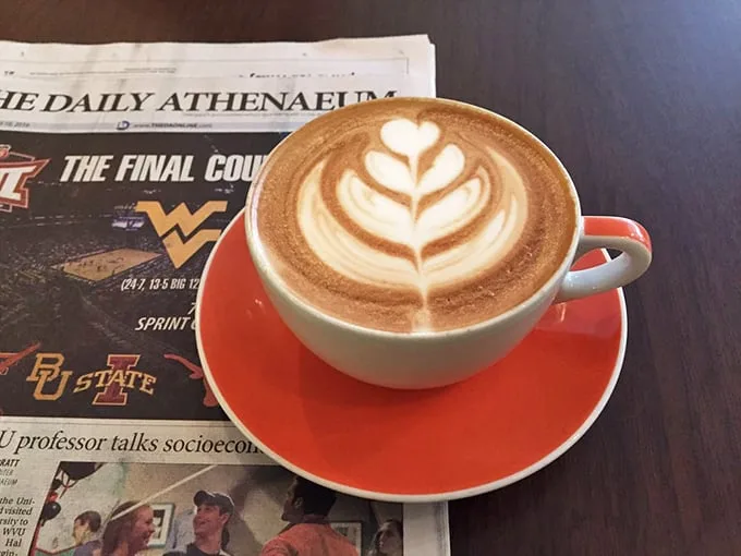 Morning news tastes better when accompanied by foam art that belongs in a gallery. The red saucer adds that extra pop of joy.