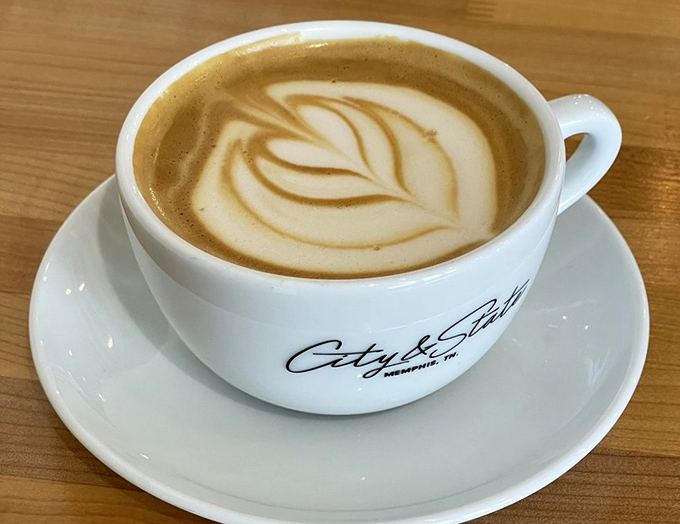 Perfection in a porcelain cup—this latte's silky microfoam creates the kind of leaf pattern that makes you hesitate before taking that first heavenly sip.