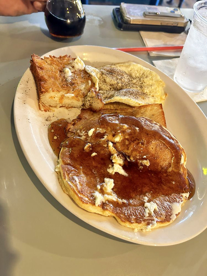 Breakfast alchemy at its finest—pancakes, eggs, and toast forming the holy trinity of morning satisfaction.