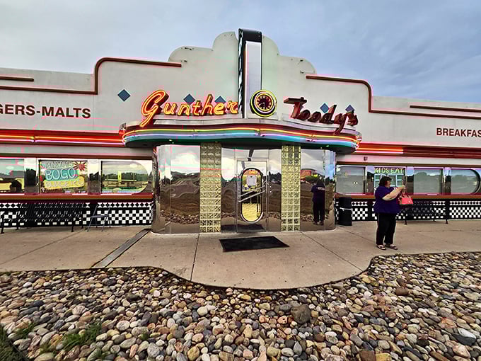 That classic "DINER" sign isn't just illuminated by neon – it glows with the promise of onion rings that crunch like vinyl records on a jukebox.