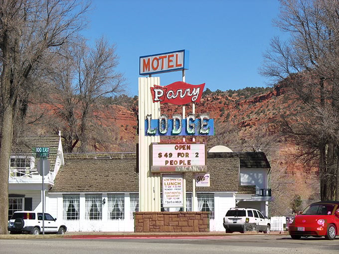The Perry Lodge sign stands as a cheerful sentinel against Kanab's dramatic red rock backdrop.