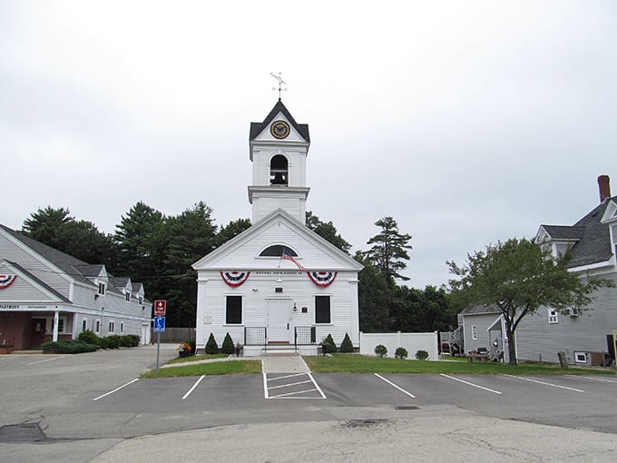 The classic white church steeple in North Hampton reaches toward blue skies—a beacon of traditional New England values and reasonable living costs.