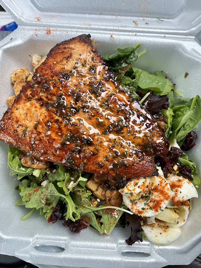 Perfectly seared salmon resting on a bed of fresh greens proves soul food isn't just about indulgence—it can have a lighter side that's equally magnificent.