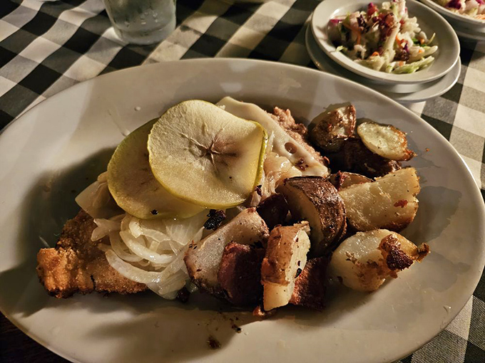 Chicken Berlin—where tender meat meets savory potatoes and a slice of apple that somehow makes perfect sense. It's like a German flavor puzzle solved on a plate.
