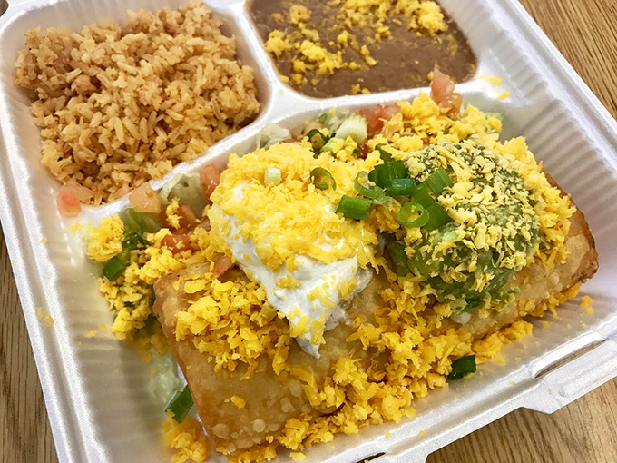 A complete flavor fiesta: the chimichanga takes center stage while Spanish rice and refried beans play perfect supporting roles in this classic combo.