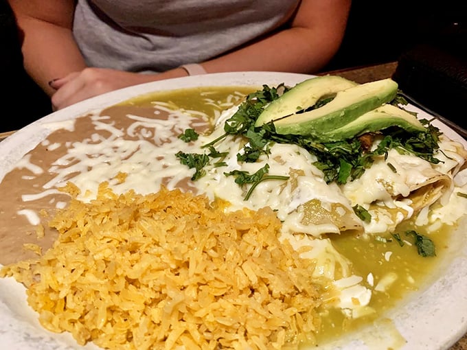 Enchiladas suizas that strike the perfect balance – creamy sauce, bright cilantro, and avocado slices that make everything in life better.
