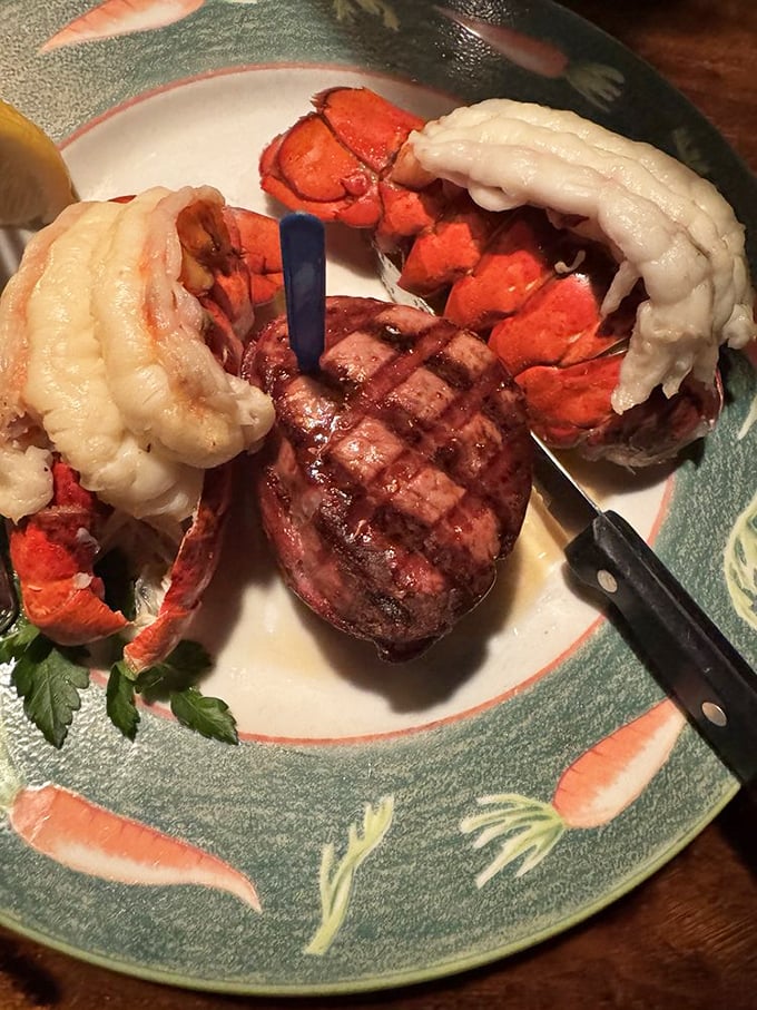 Surf and turf nirvana! A perfectly grilled filet mignon playing harmony with twin lobster tails—proof that land and sea can coexist deliciously on one plate.