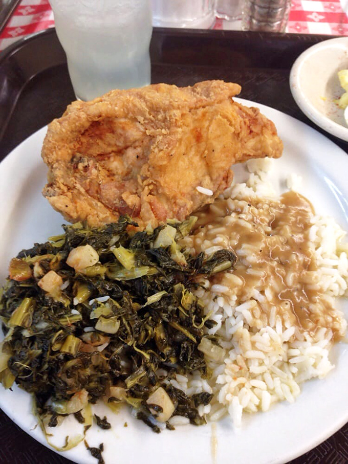 This isn't just lunch – it's a Southern passport stamped with crispy chicken, collard redemption, and rice awaiting gravy's warm embrace.