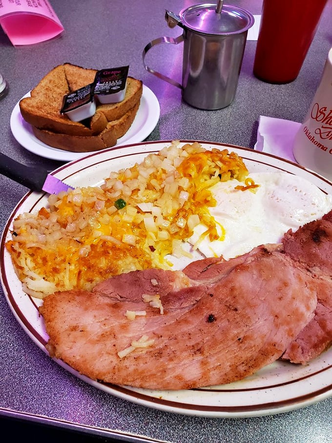 Ham that's been kissed by the griddle pairs with eggs and cheese-topped hash browns—a plate that says "good morning" better than words ever could.