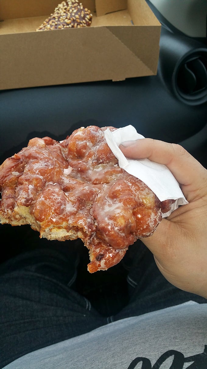 This isn't just a fritter—it's edible architecture with neighborhoods of apple chunks and suburbs of cinnamon crackle. Worth every calorie.