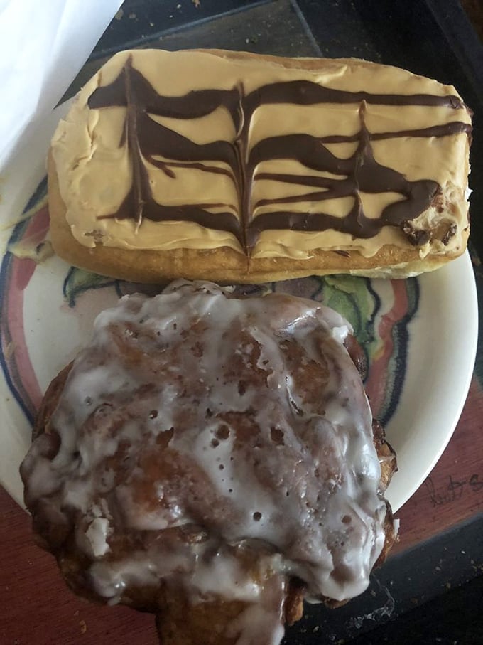 The yin and yang of donut perfection—an elegant long john with chocolate artistry alongside the beautiful chaos of a glazed fritter.