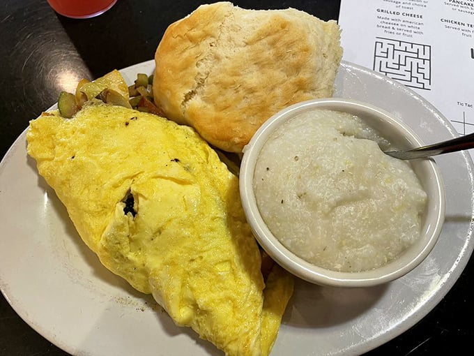 This fluffy omelet with a side of grits and biscuit isn't just breakfast—it's edible Southern hospitality on a plate.