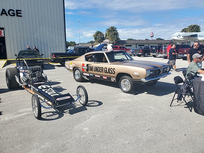 When dragsters venture outdoors—a rare sight, like seeing nocturnal creatures in daylight. The Plymouth's "Team Under Glass" livery gleams in Florida sunshine.