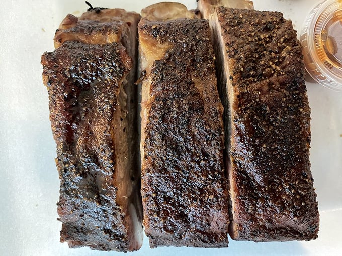 The bark on these ribs is like nature's candy—a peppery, caramelized crust protecting meat that's tender without falling apart at first touch.