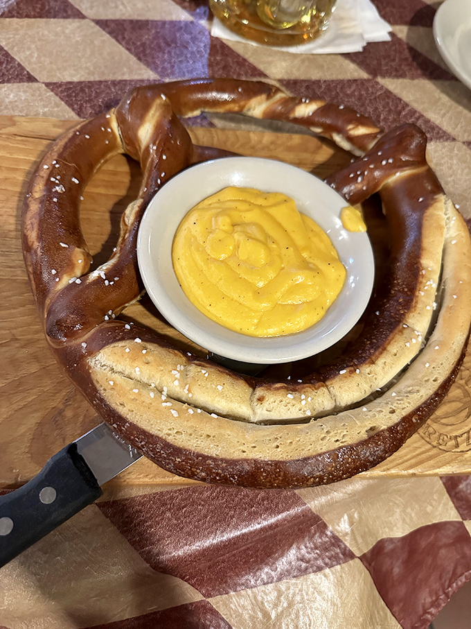 That vibrant yellow cheese sauce isn't just a dip—it's a molten treasure bath waiting for your pretzel to take the plunge. Resistance is futile.