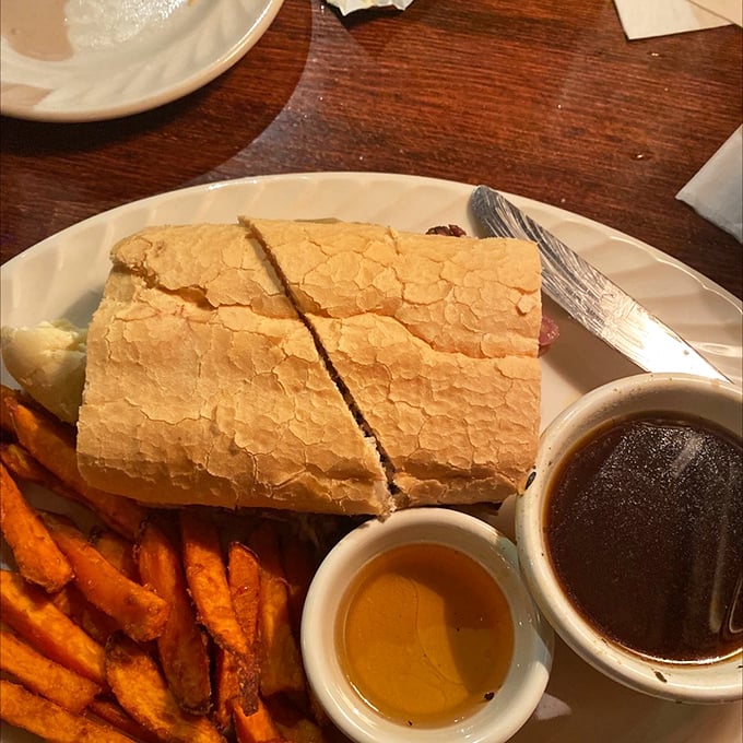 Not all heroes wear capes—some come between bread slices with sweet potato fries and dipping sauces that make you question all other sandwiches.