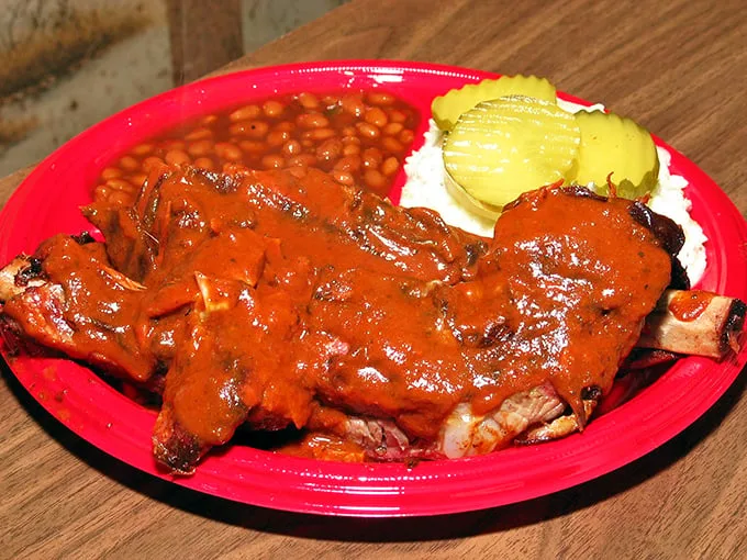 These ribs aren't just sauced – they're baptized. The deep red coating promises a flavor revelation that borders on religious experience.