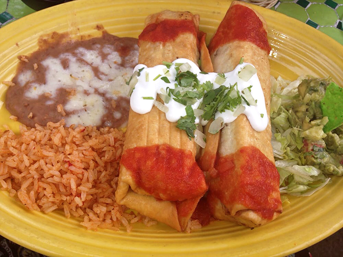 These enchiladas wear their red sauce like a fashionable jacket—just enough to make a statement without overwhelming the delicate flavors inside.