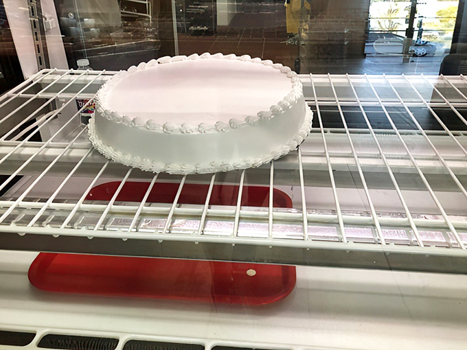 Simplicity at its finest—a classic white cake awaiting its destiny. Like a blank canvas before Picasso, this cake holds infinite sweet possibilities.